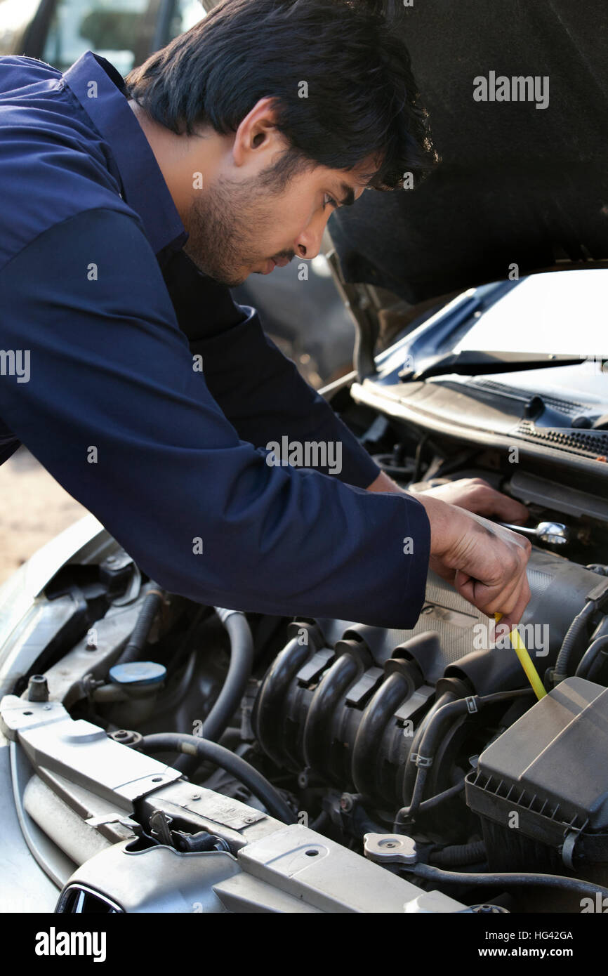 Mechanic repairing car engine Stock Photo - Alamy