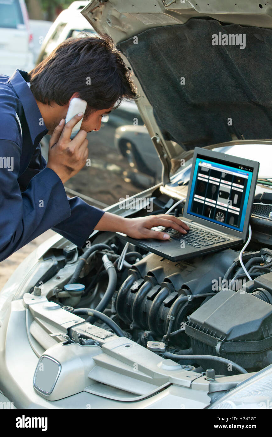 Mechanic looking service information hi-res stock photography and ...