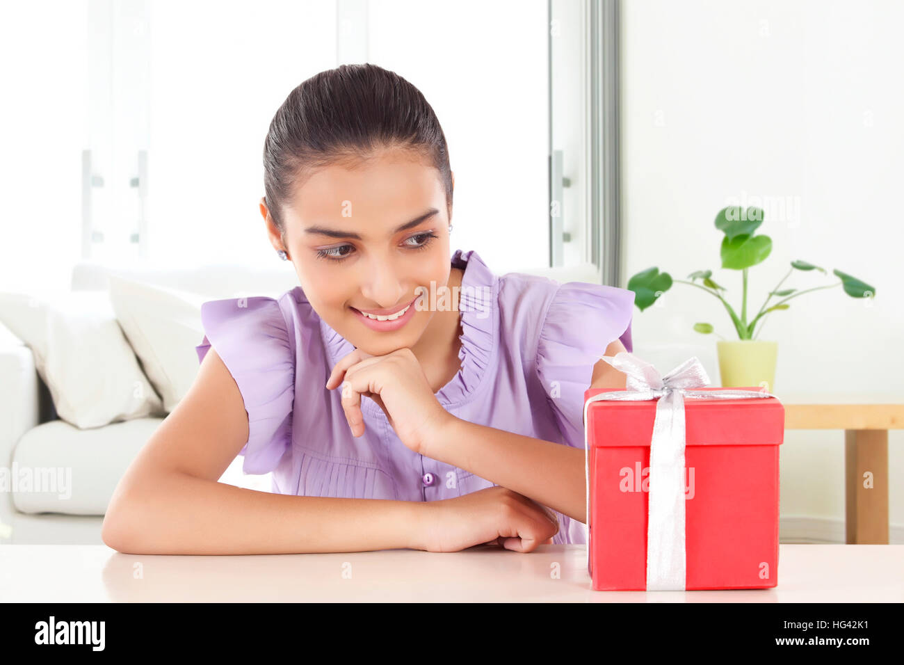 Happy Teenage Girls holding gift with ribbon Stock Photo - Alamy