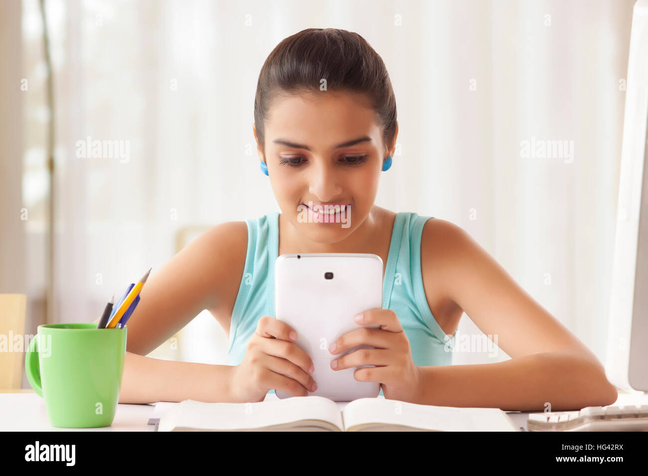 Teenage Girls student at home using digital tablet Stock Photo - Alamy