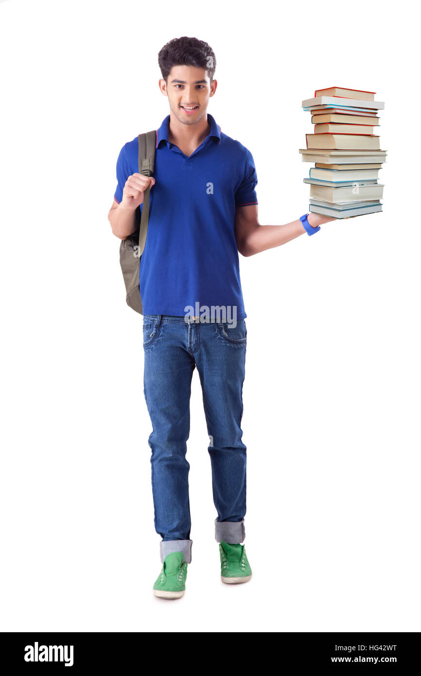Young Man Standing With Stack of books in hand, isolated on white ...