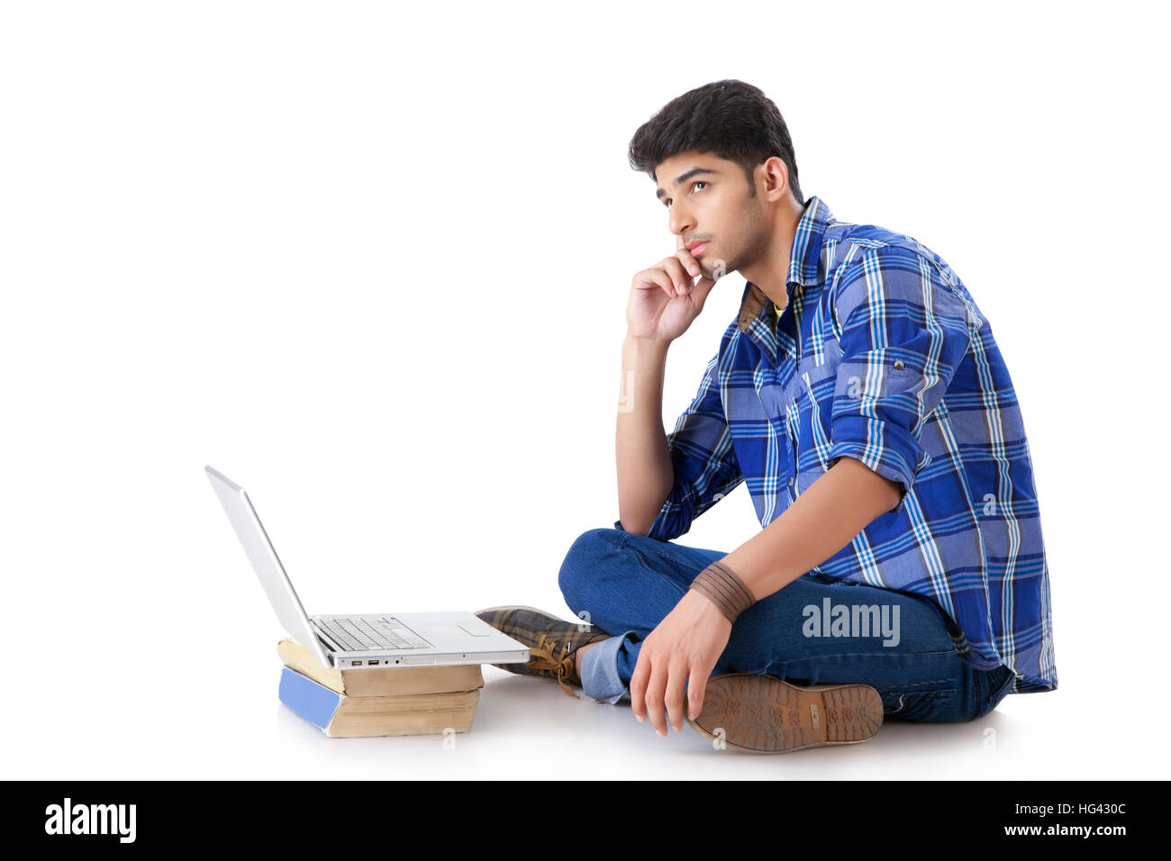 Portrait of a man using a laptop and thinking Stock Photo - Alamy