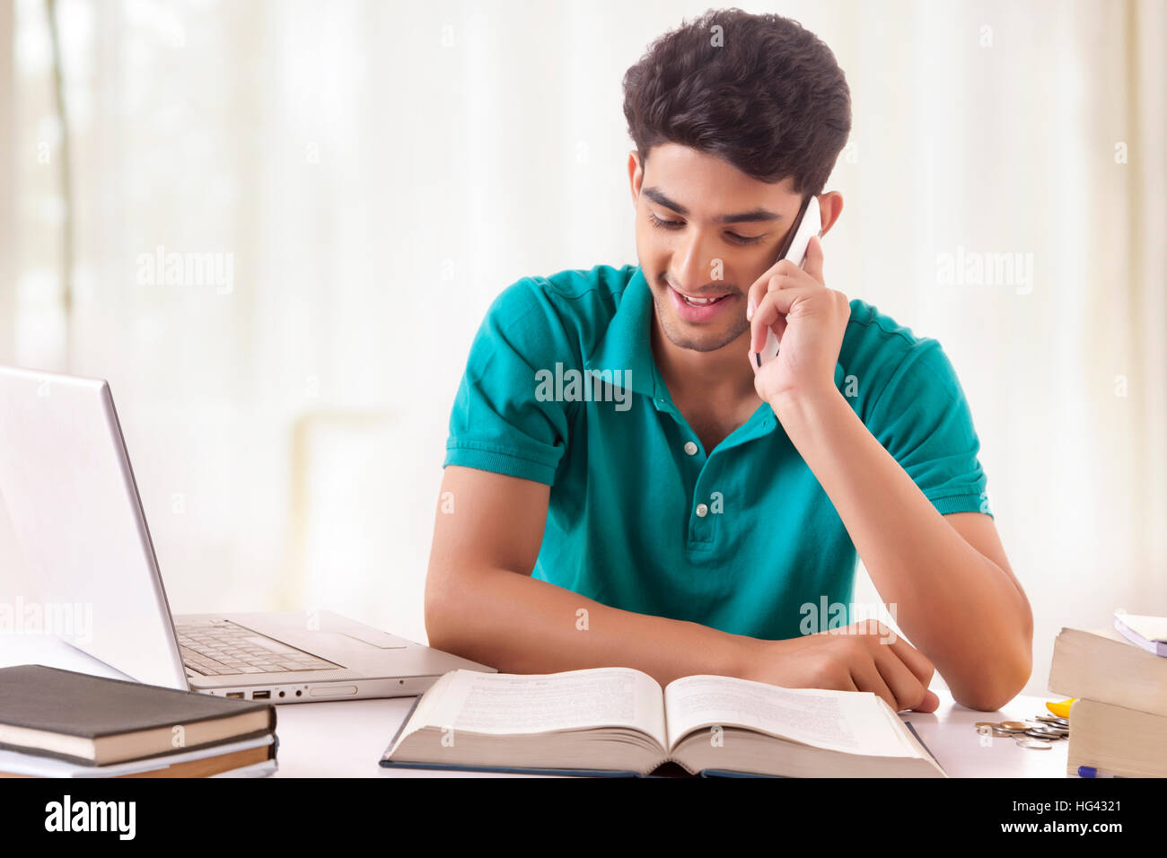 Student with Mobile Phones at the desk Stock Photo - Alamy