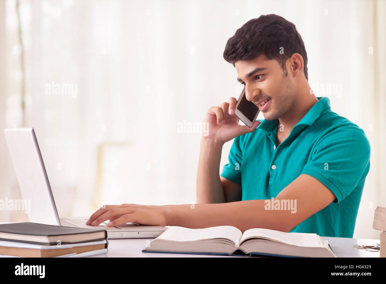 Student using Mobile Phones at the desk Stock Photo - Alamy