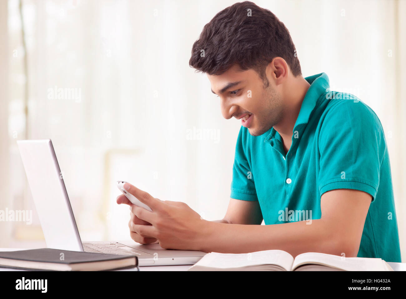 Student using Mobile Phones at the desk Stock Photo - Alamy