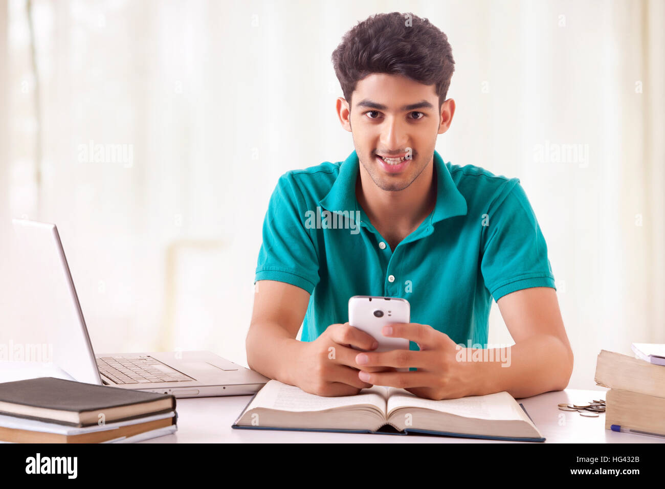 Student using Mobile Phones at the desk Stock Photo - Alamy