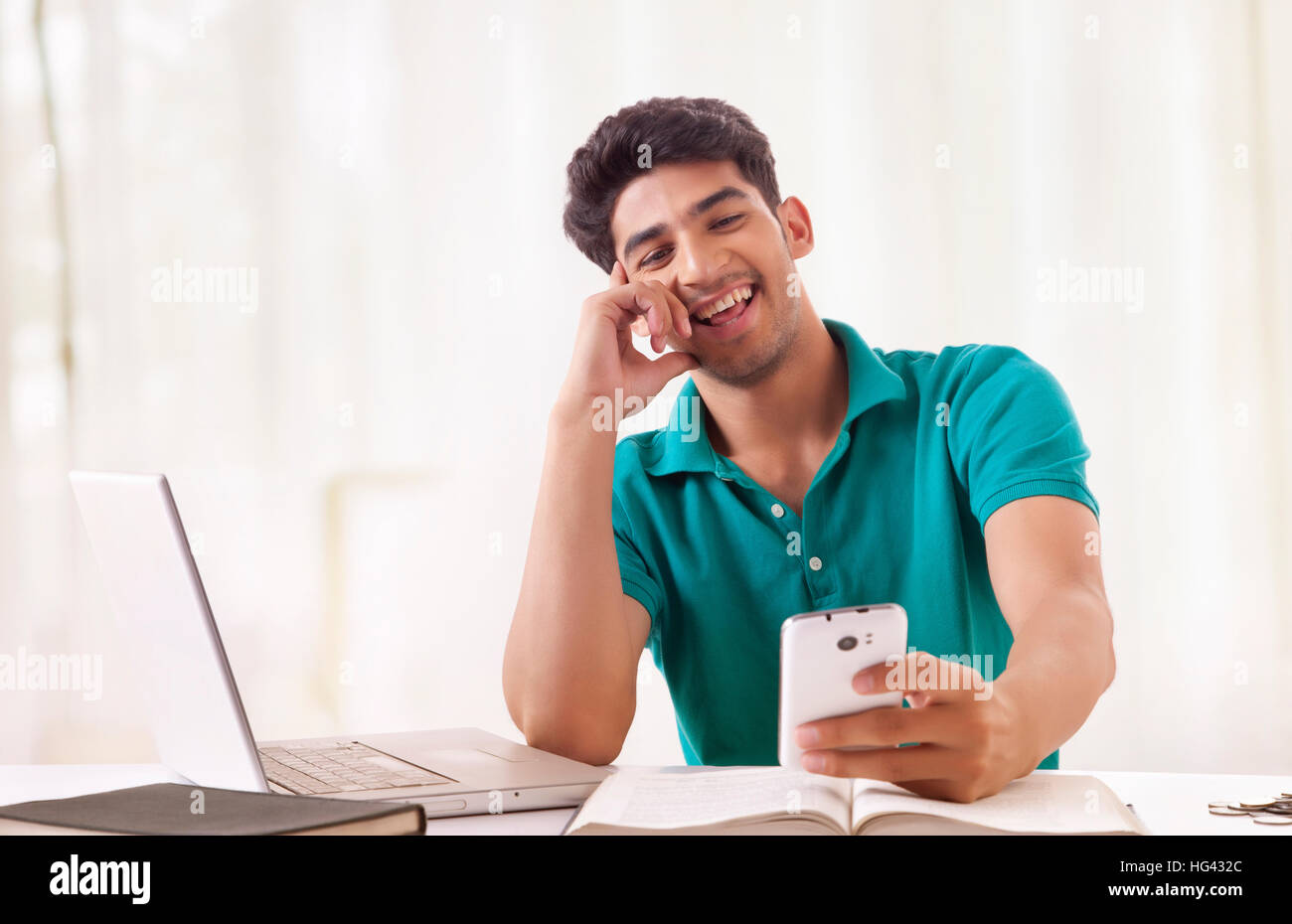 Student using Mobile Phones at the desk Stock Photo - Alamy