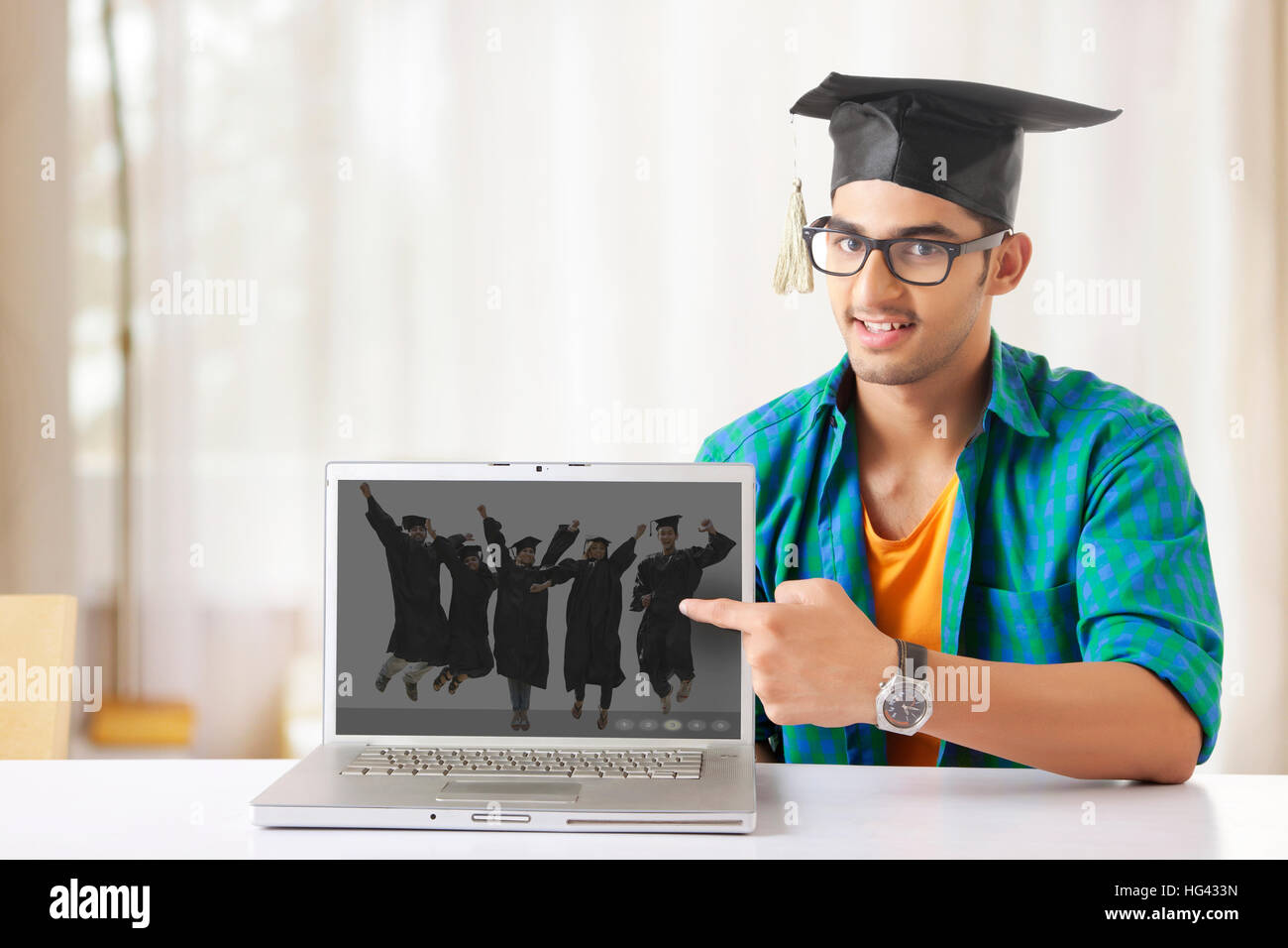 Young Man Pointing At Laptop Stock Photo - Alamy