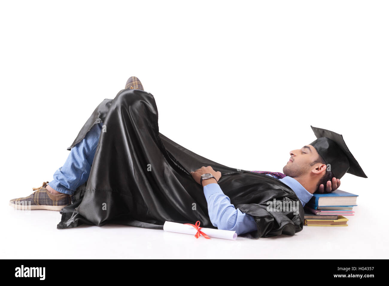 College graduate student resting head on stack of books Stock Photo - Alamy