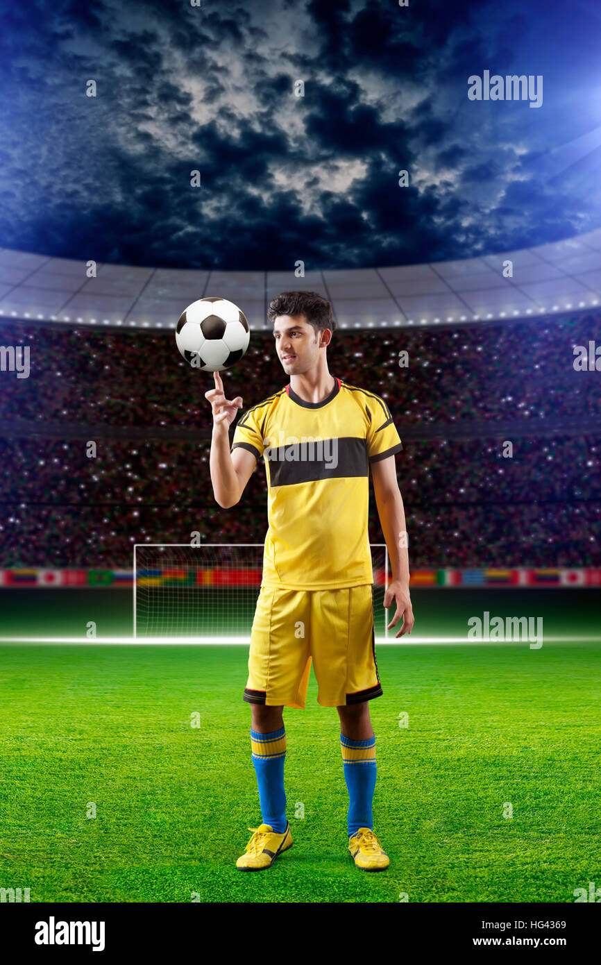 Football player balancing Football on his finger Stock Photo - Alamy