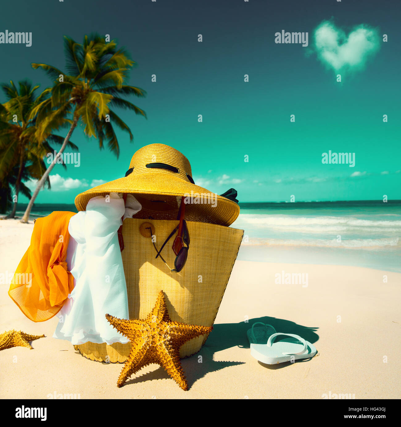 Art Straw hat, bag, sun glasses and flip flops on a tropical beach ...