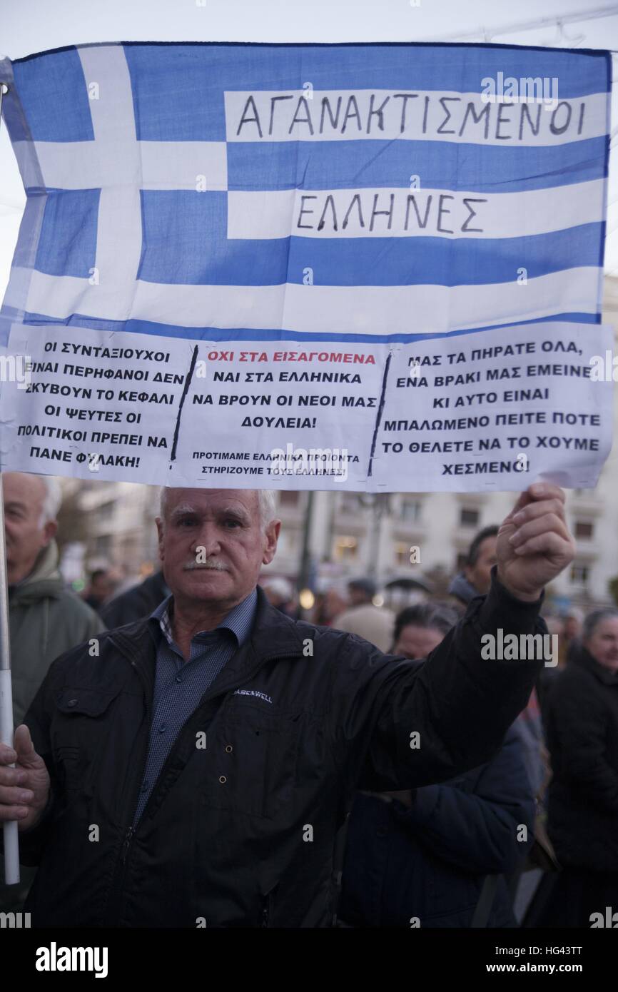 Greek pensioner with Greek flag "Angry Greeks", during protest of Greek ...