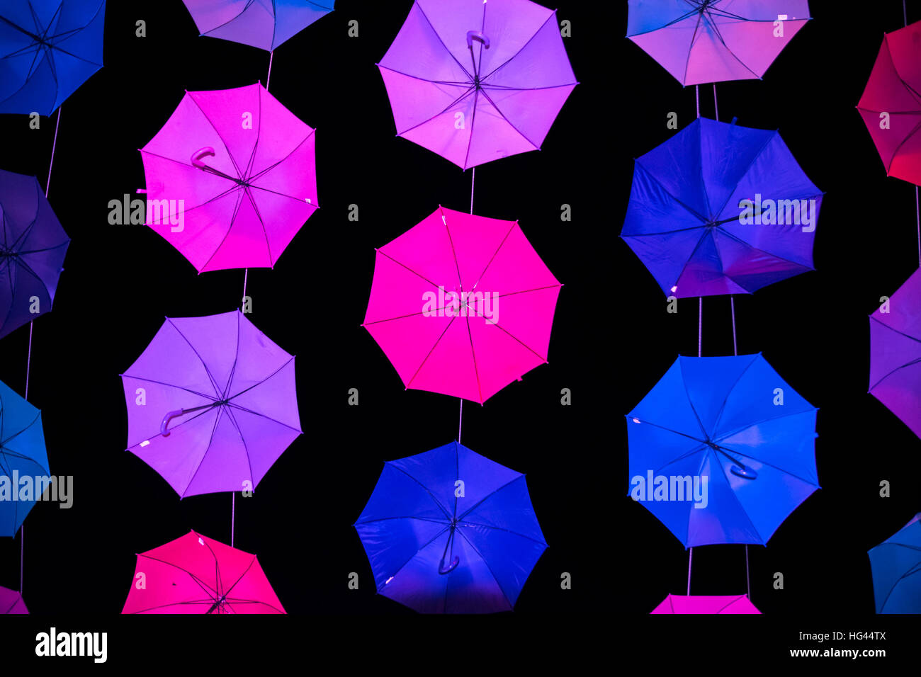 Colored open umbrellas on a black background Stock Photo - Alamy