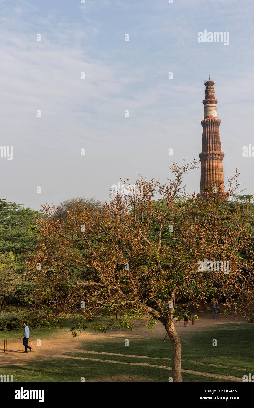People playing cricket in mehrauli archaeological park and Qutub Minar ...