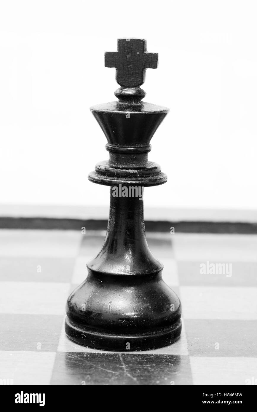 Lone king on a chessboard on white background Stock Photo - Alamy
