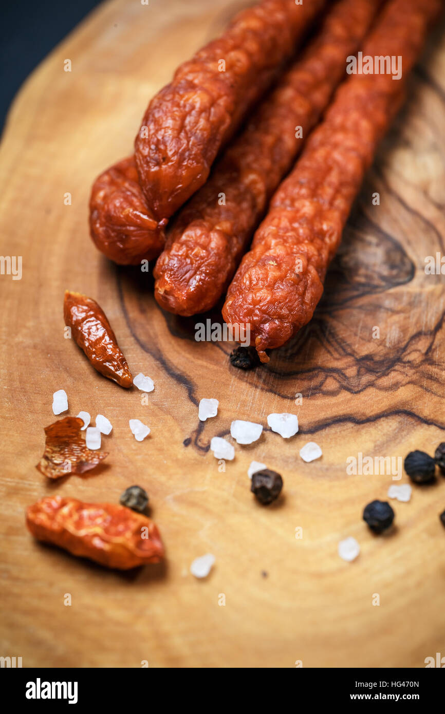 Closeup of fresh thin sausages on wooden background Stock Photo - Alamy