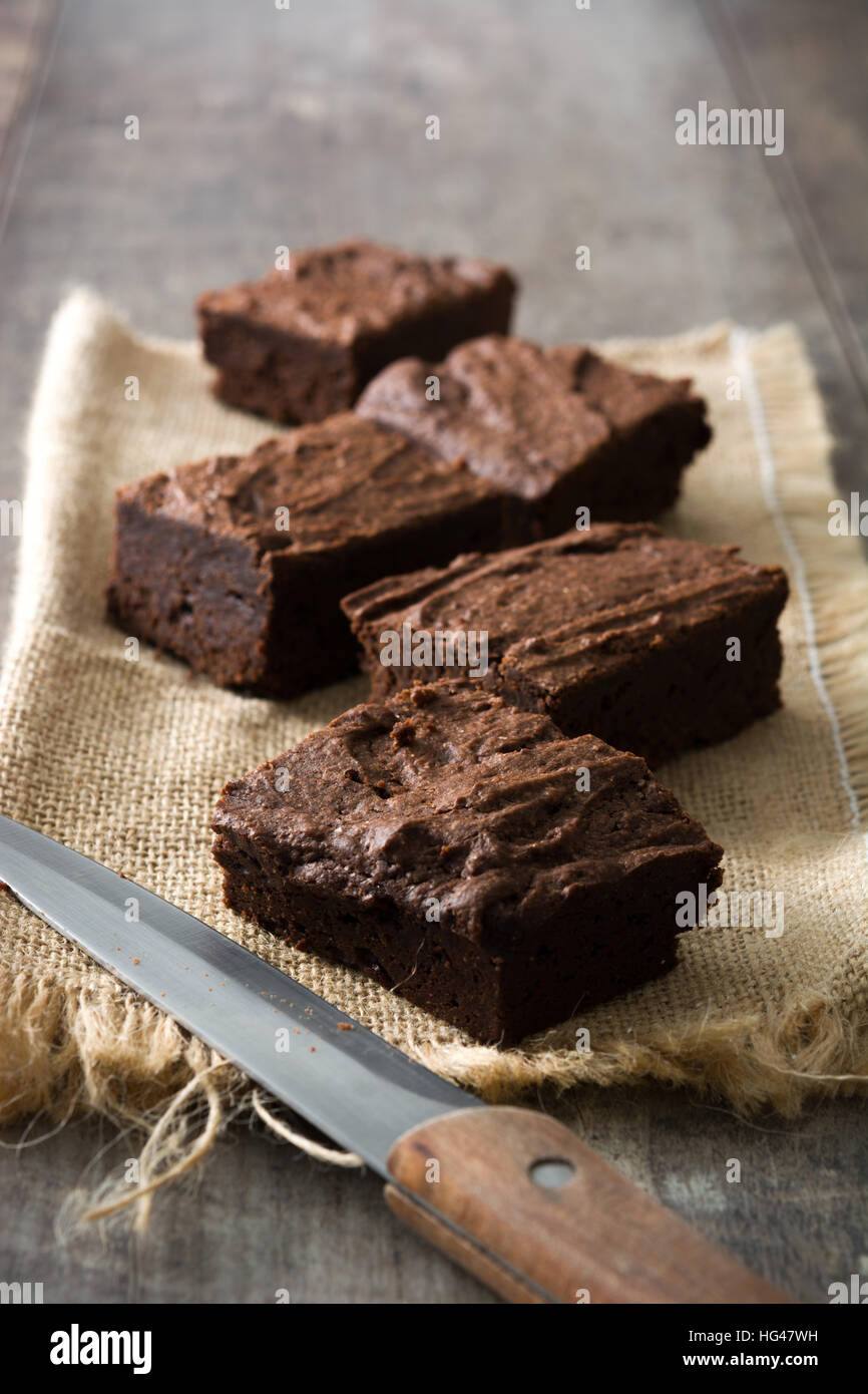 Chocolate brownie portions on wooden background Stock Photo - Alamy