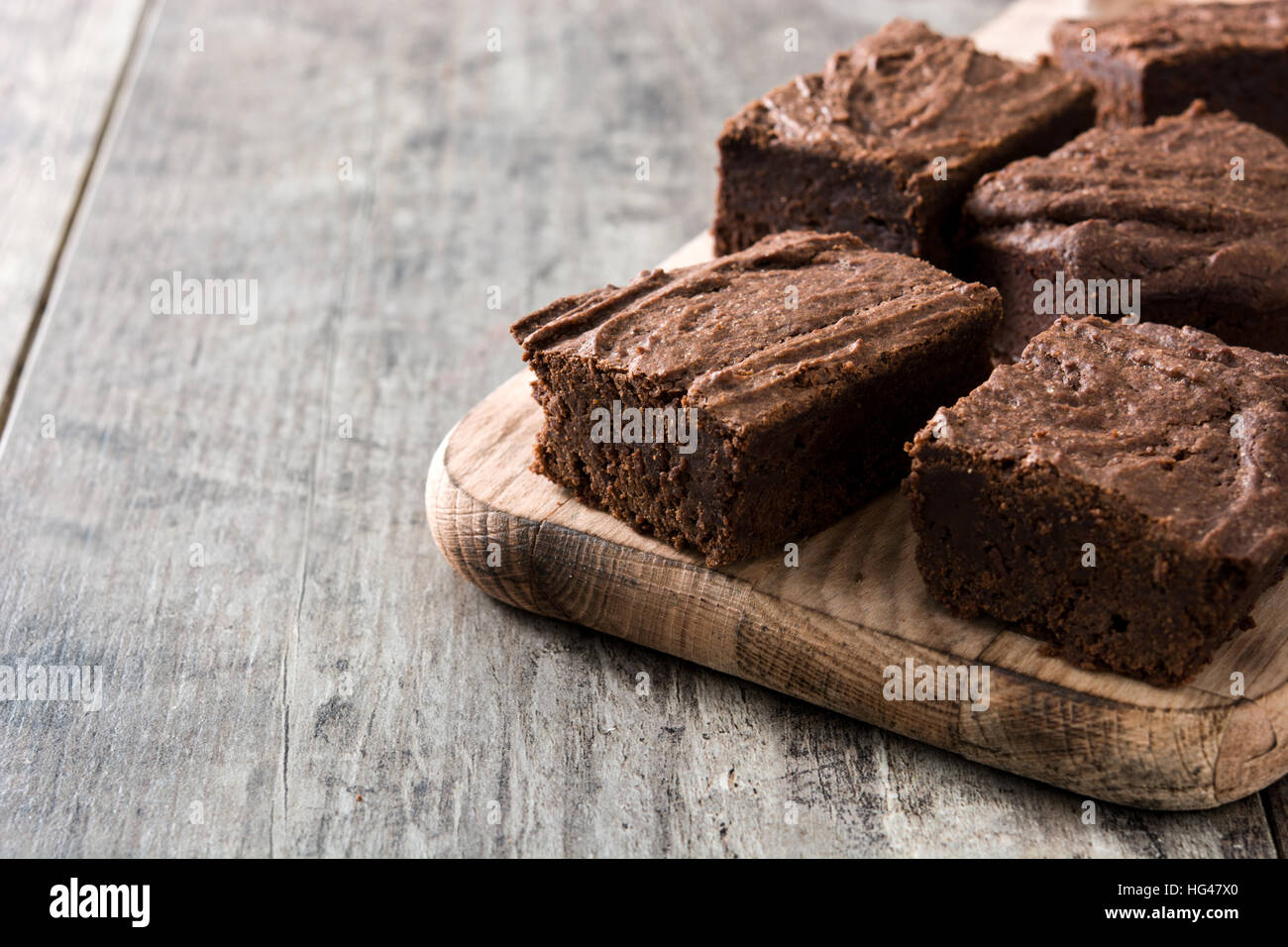 Chocolate brownie portions on wooden background Stock Photo - Alamy