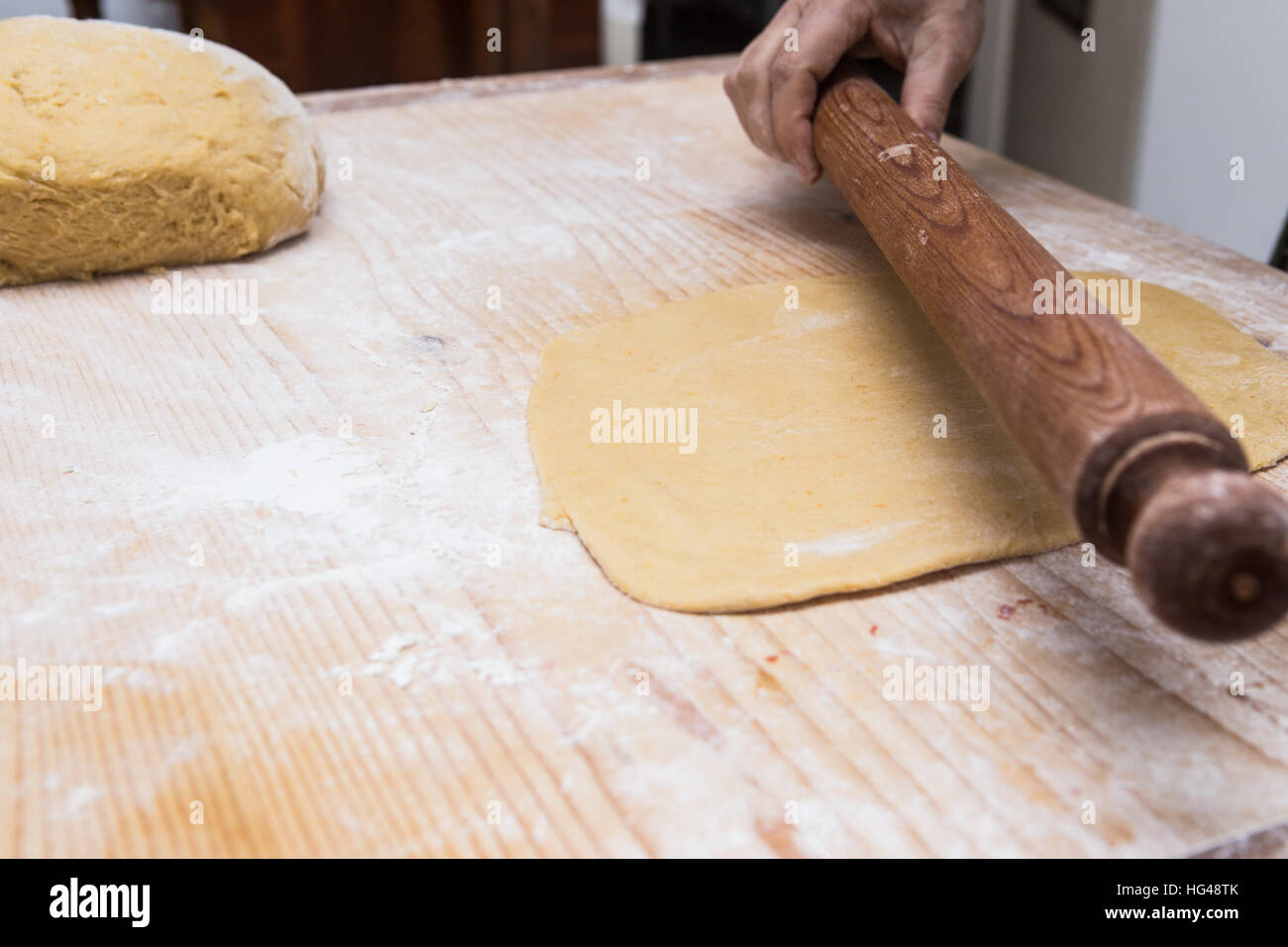 Woman hands kneading dough on kitchen table with rolling pin Stock ...