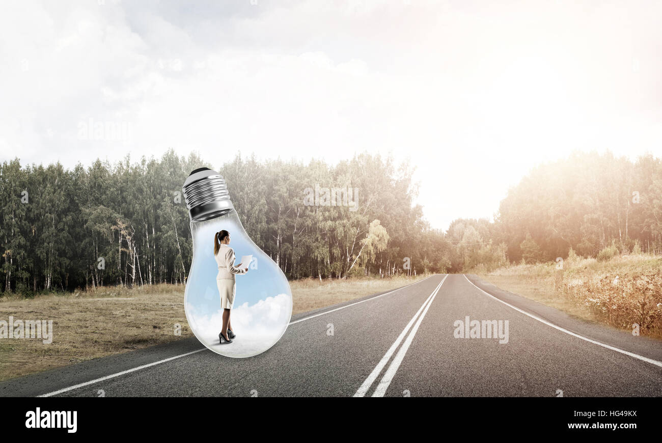 Businesswoman inside light bulb Stock Photo - Alamy