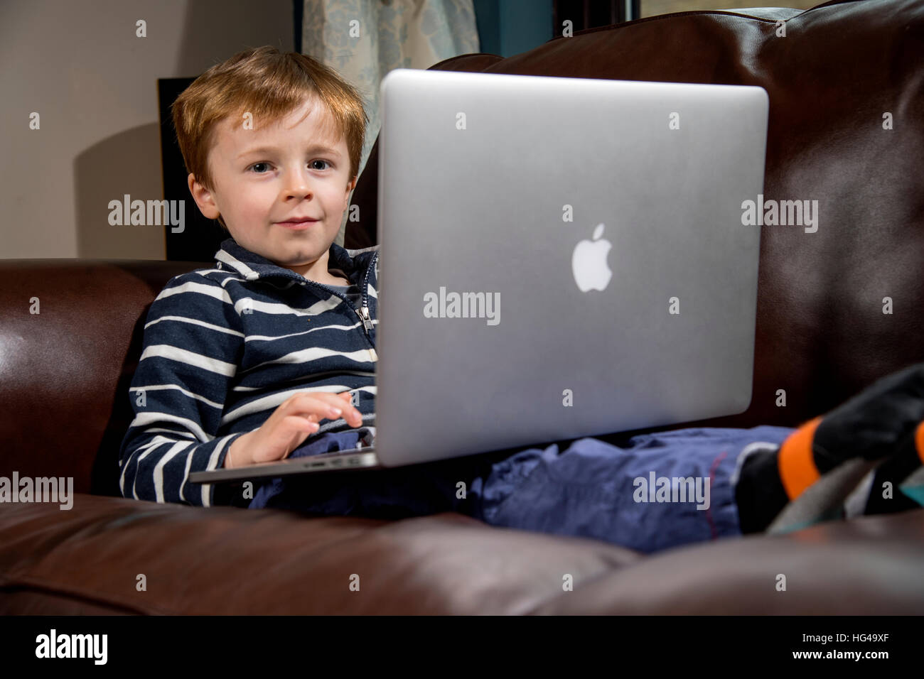 Child using technology. 5 year old boy with a laptop computer Stock ...