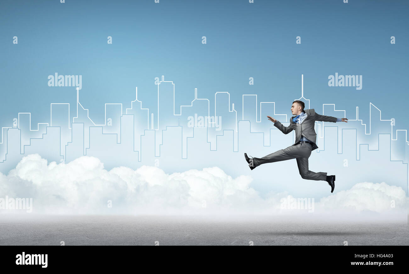 Businessman jumping high Stock Photo - Alamy