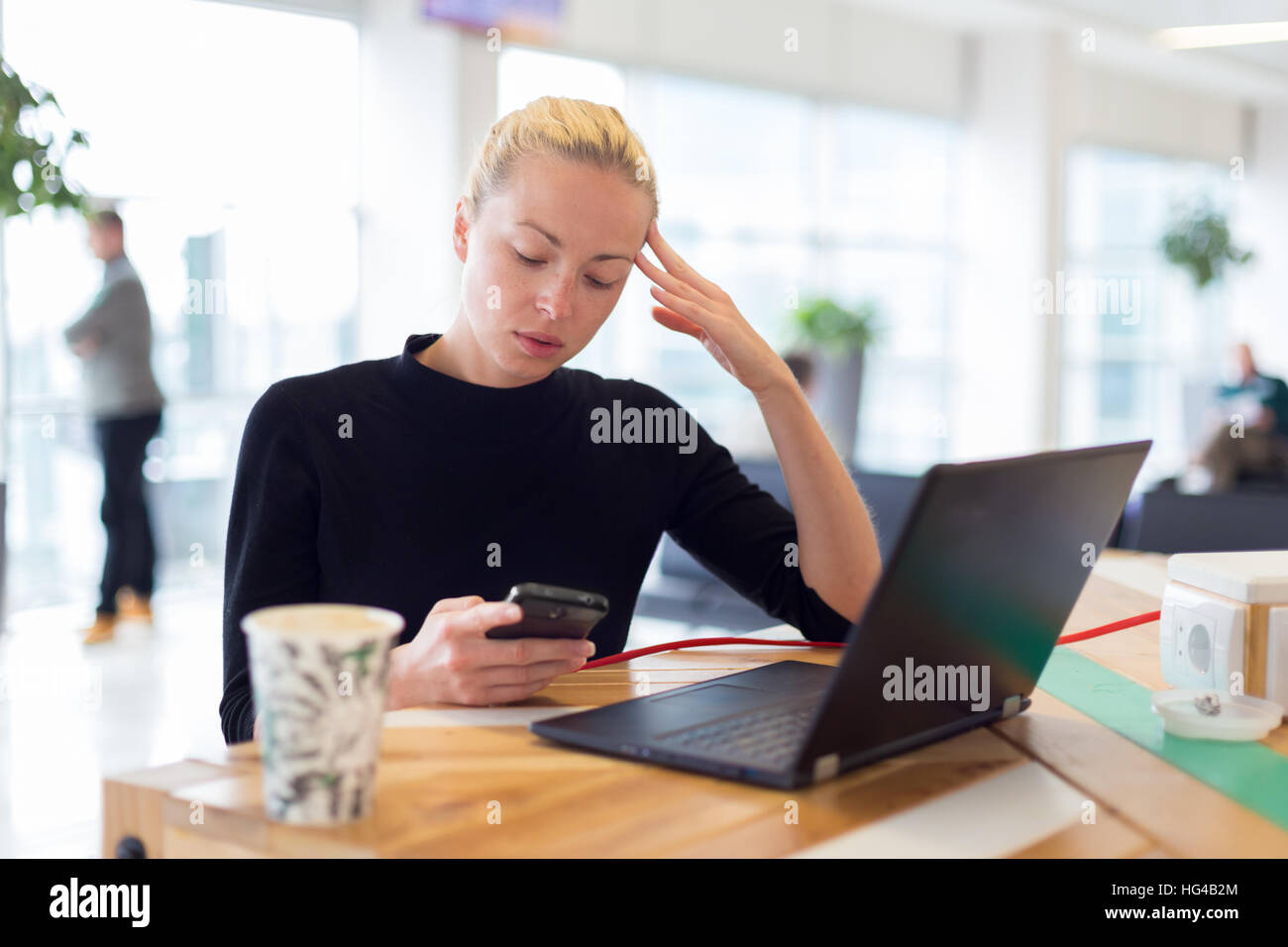 Female freelancer working remotely using hi-res stock photography and ...