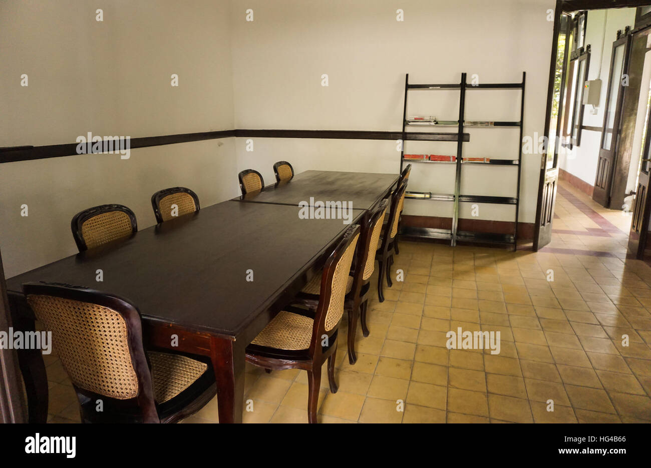 Set of large table and chairs in the middle of a room at Lawang Sewu ...