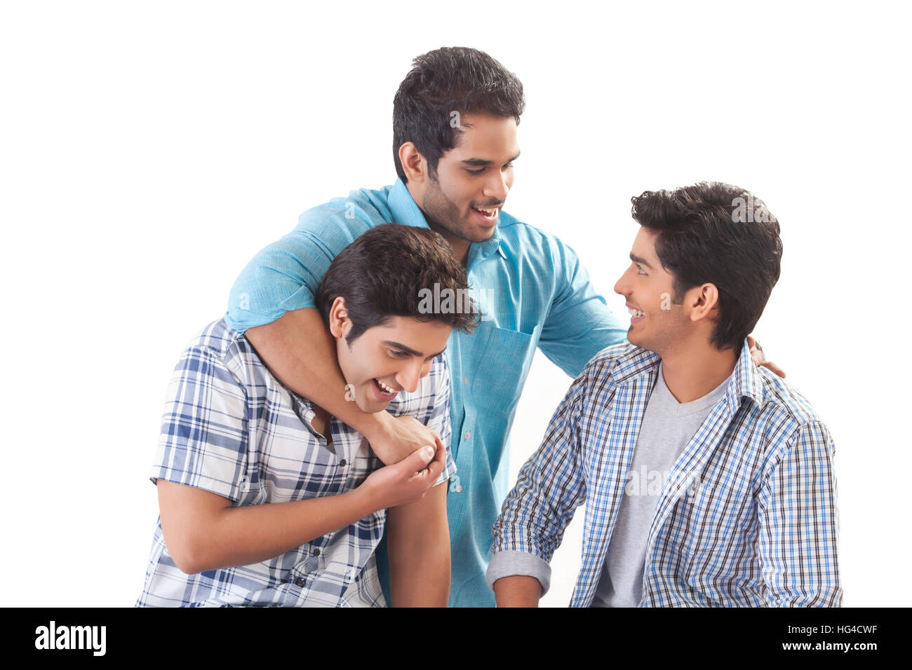 Three friends laughing Stock Photo - Alamy