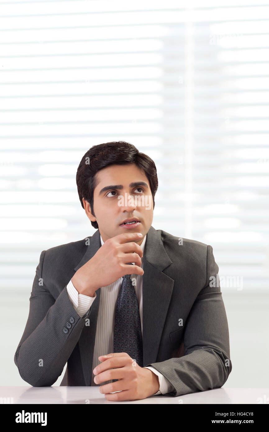 Portrait of businessman thinking Stock Photo - Alamy