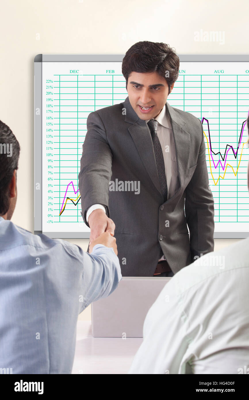 Businessman extending hand for handshake Stock Photo - Alamy