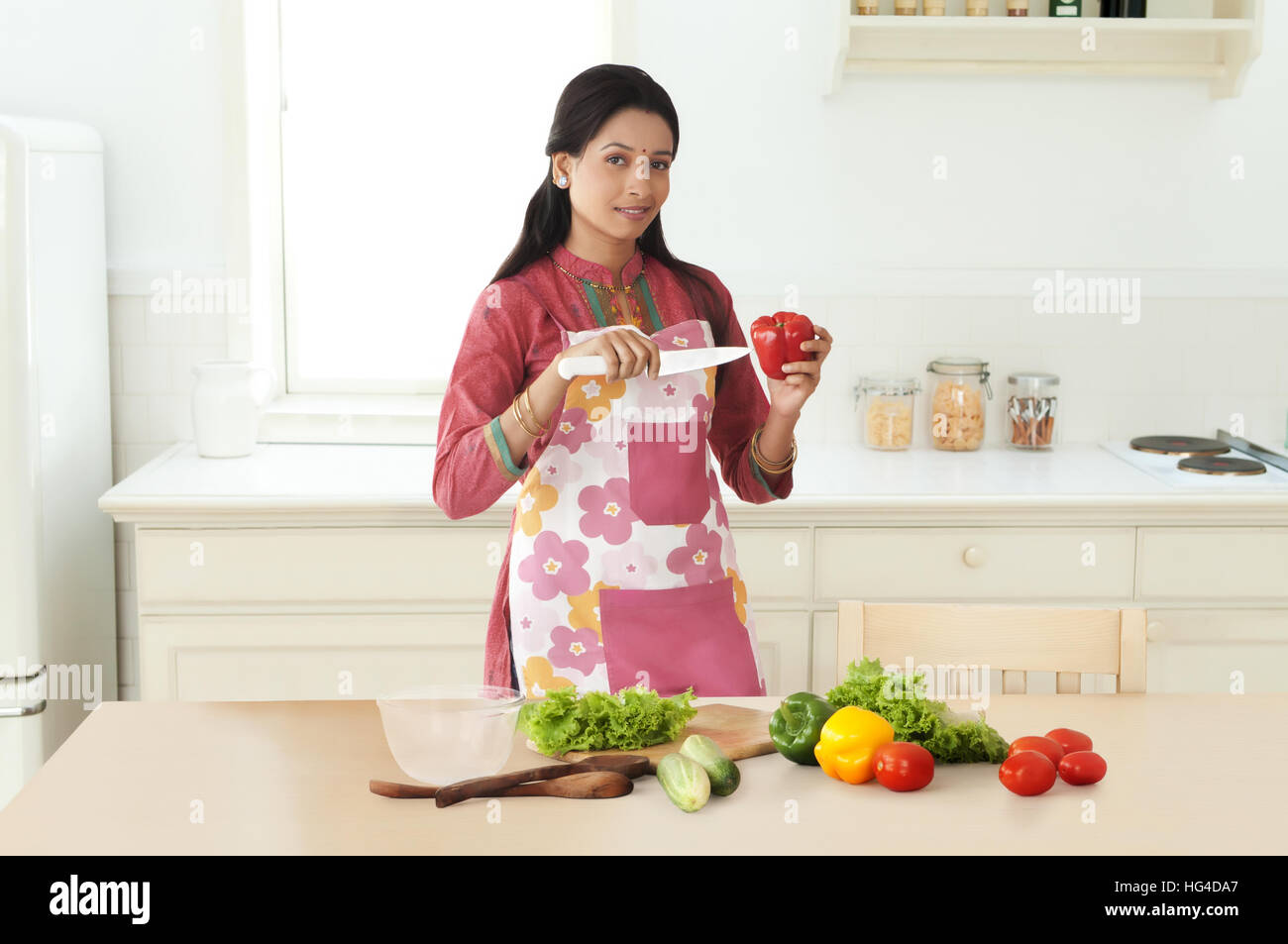 Woman holding capsicum and knife Stock Photo - Alamy
