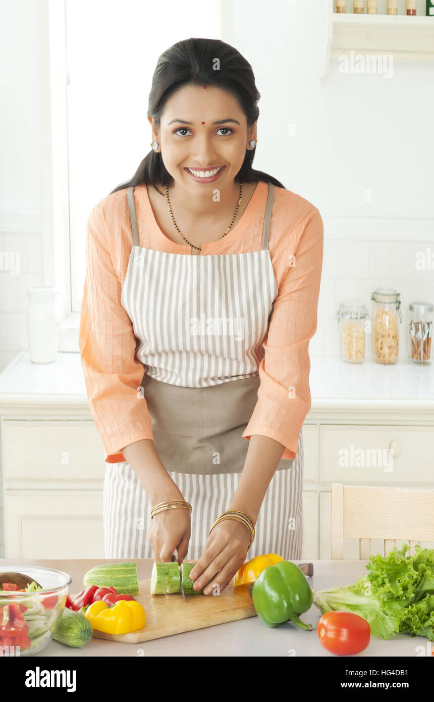 Woman holding salad bowl in kitchen Stock Photo - Alamy