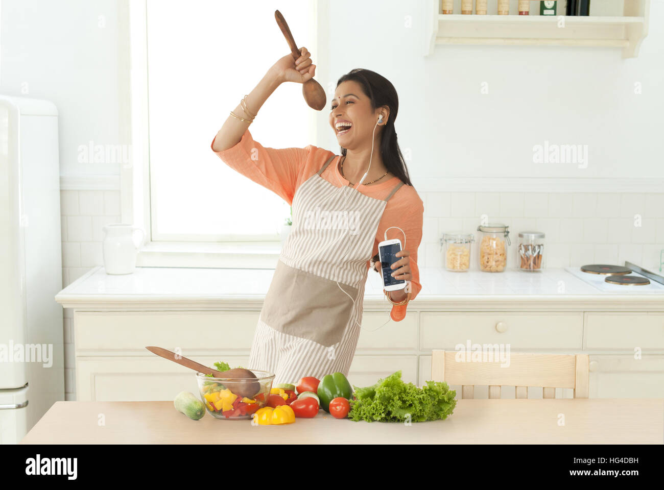 Woman singing in kitchen Stock Photo - Alamy