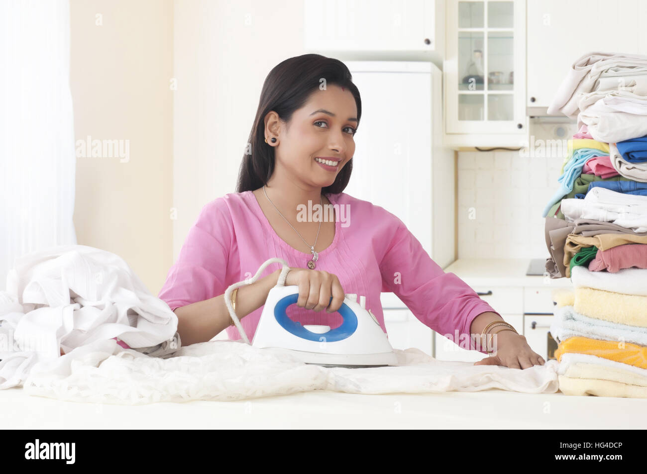 Woman ironing clothes Stock Photo - Alamy