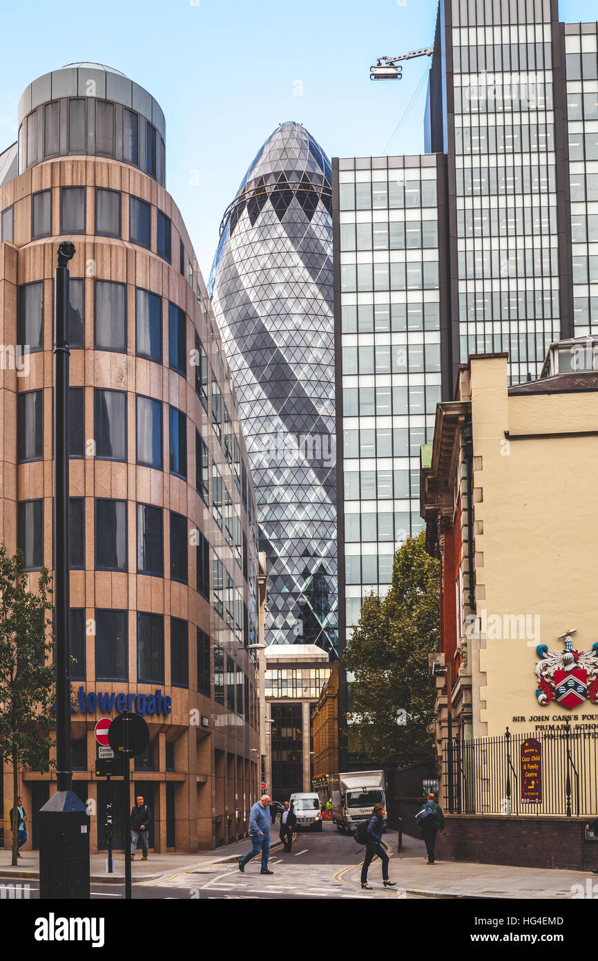 London UK, People crossing neat The Gherkin Tower building and the ...