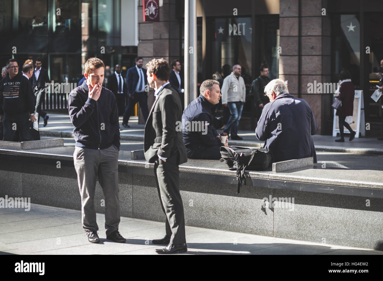 London lunch break outside the Gherkin. People drinking a coffee on the ...