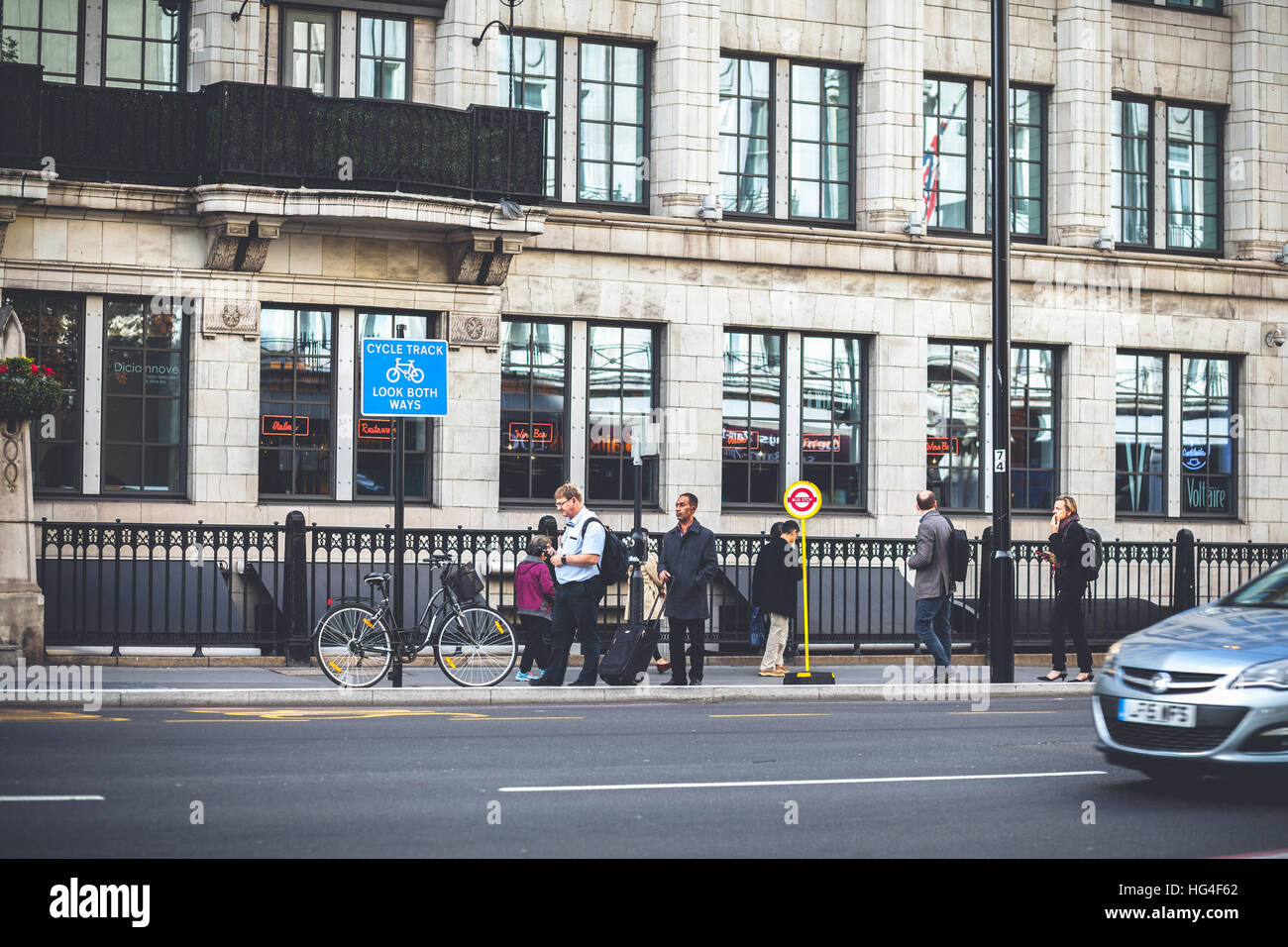 People on sidewalk waiting in bus station in London Stock Photo - Alamy
