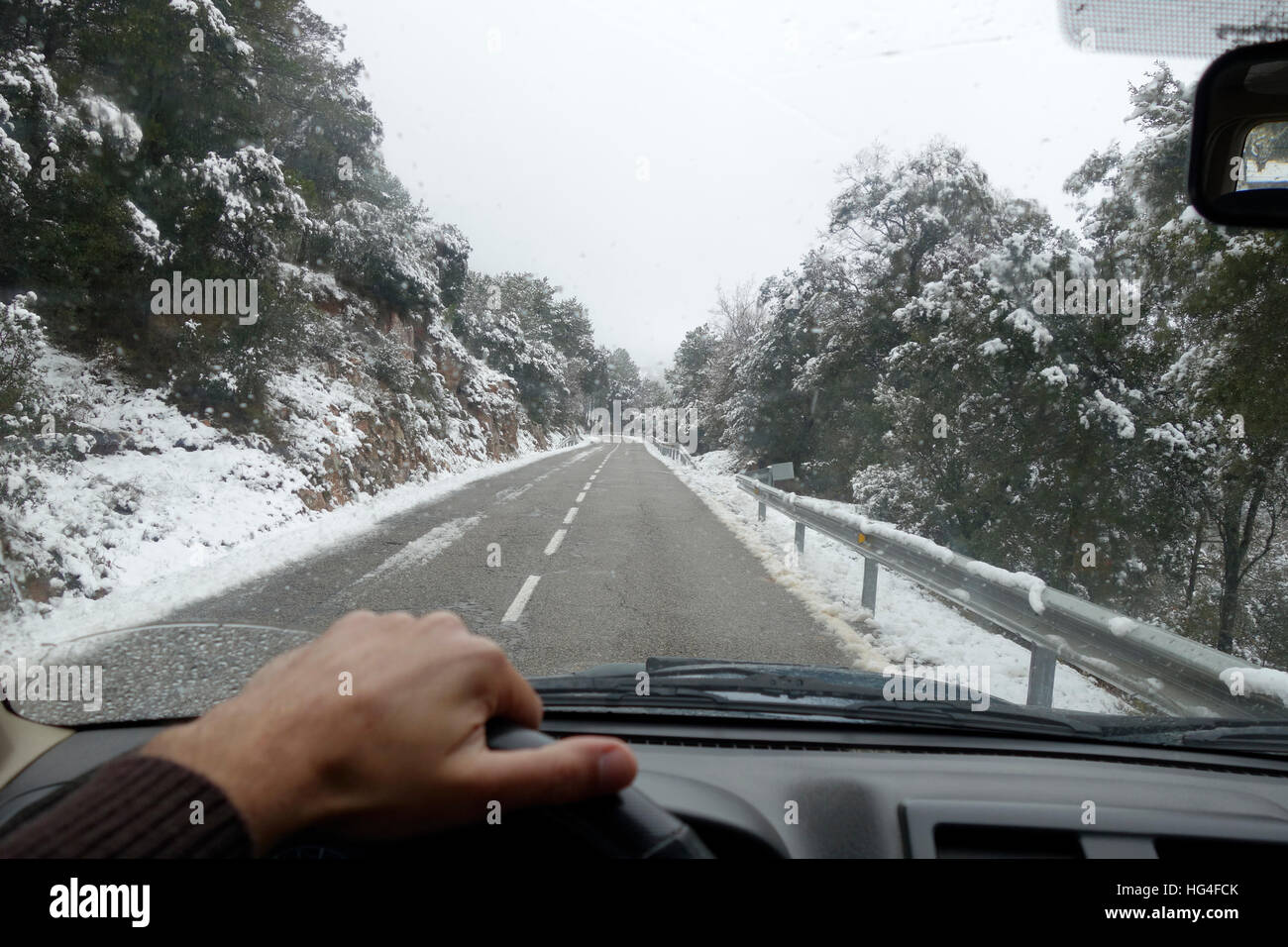 Driving a car at winter with snow in the road Stock Photo - Alamy