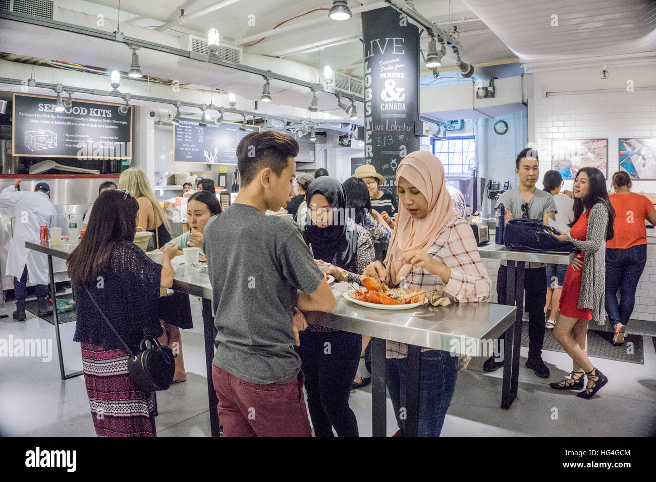 Muslim mother wearing headscarf at stand up counter sharing whole ...