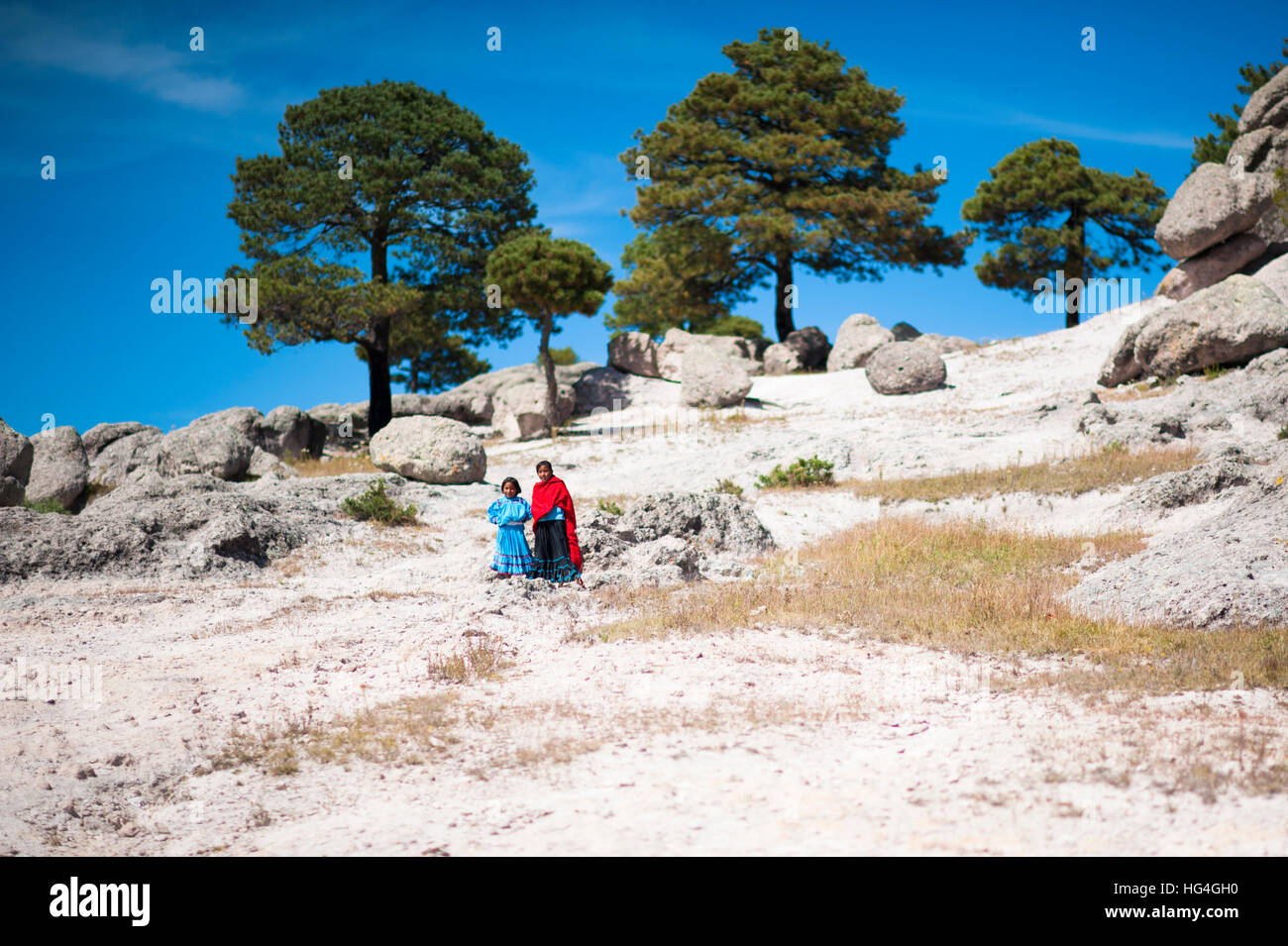Two colorful angels walking in the arid mountain Stock Photo - Alamy