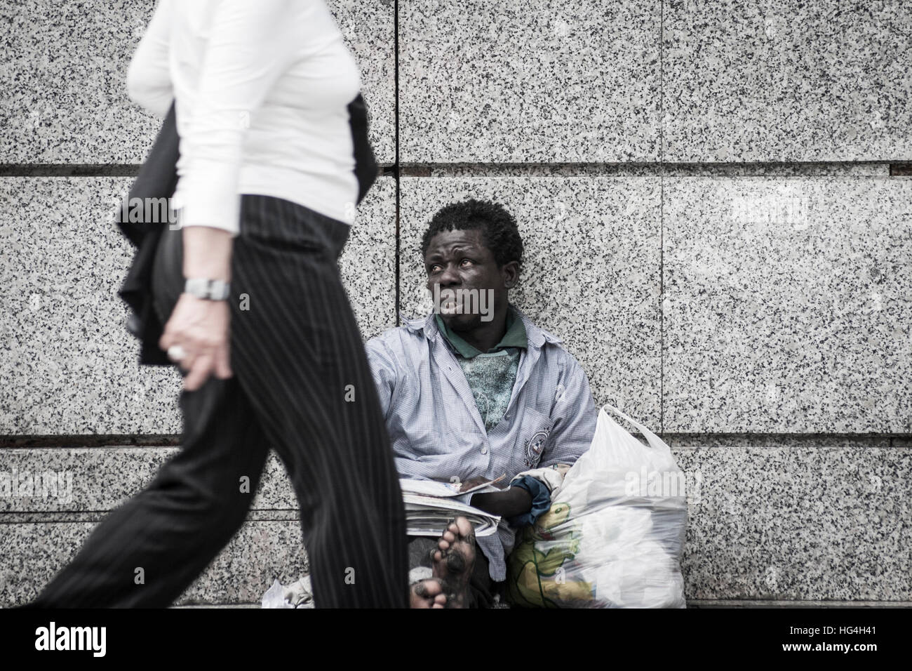 Homeless man begging outside department store in Spain Stock Photo - Alamy