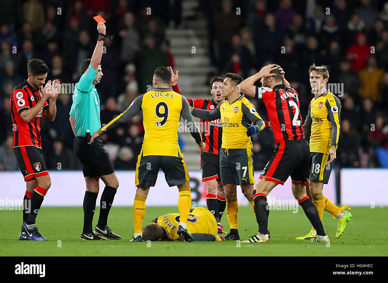 Referee Michael Oliver shows AFC Bournemouth's Simon Francis the red ...