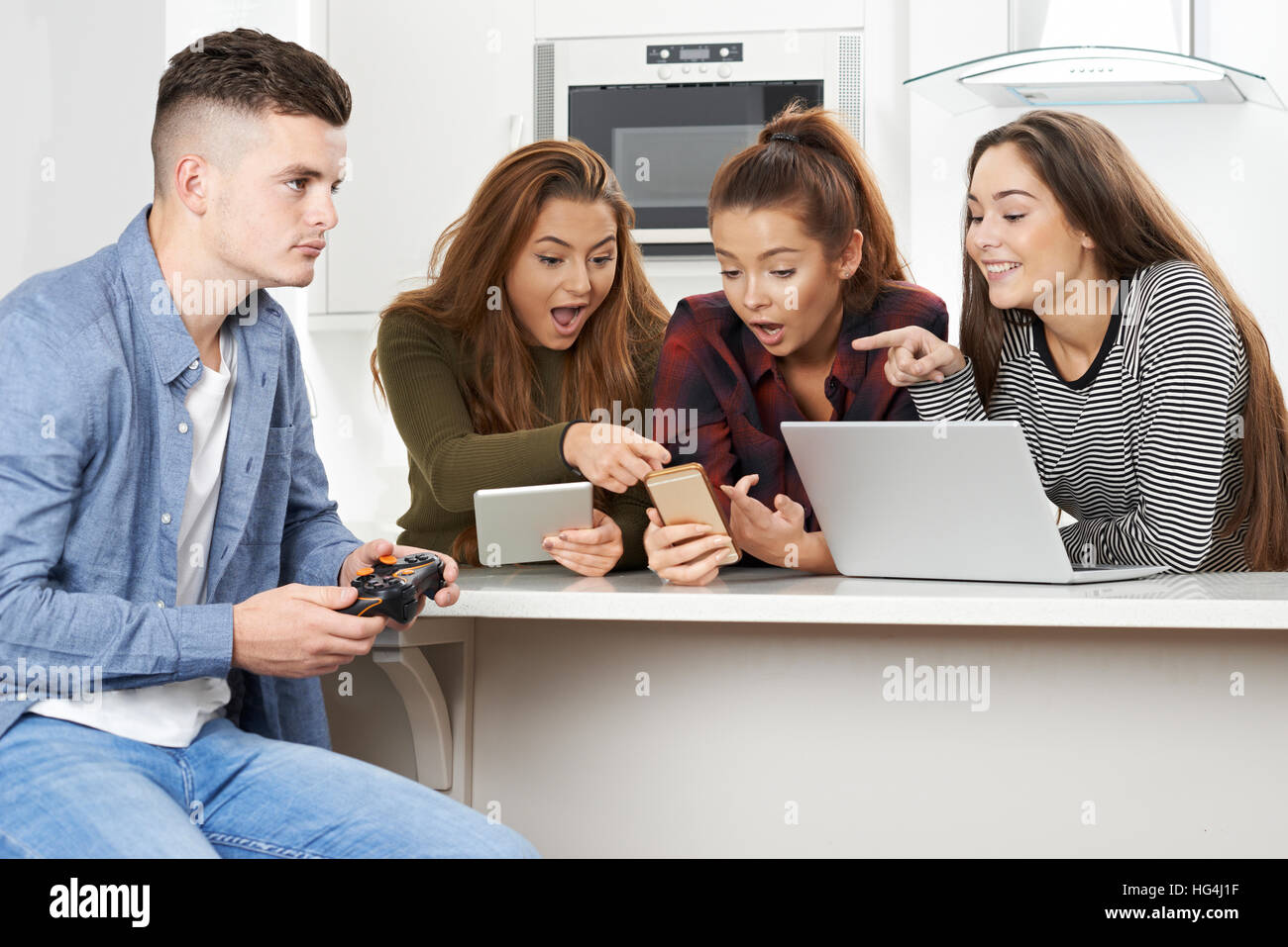 Group Of Teenagers Using Digital Technology At Home Stock Photo - Alamy
