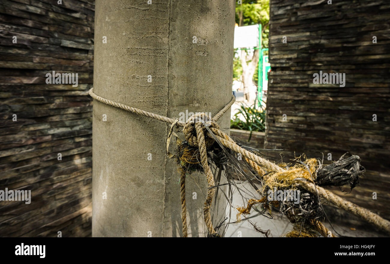 plastic rope bound to a concrete pillar photo taken in Semarang ...