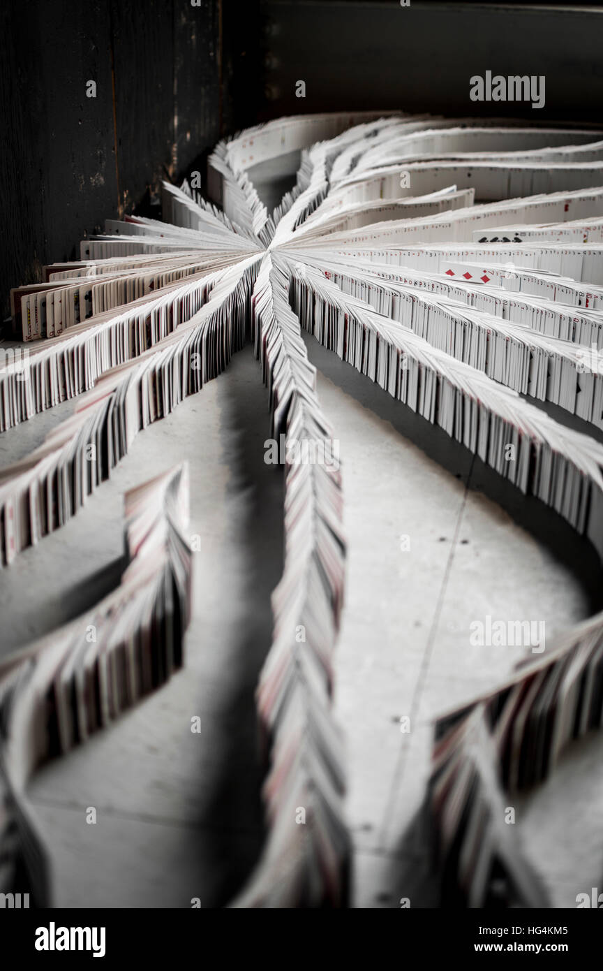 playing cards stacked in a web formation like dominoes Stock Photo - Alamy