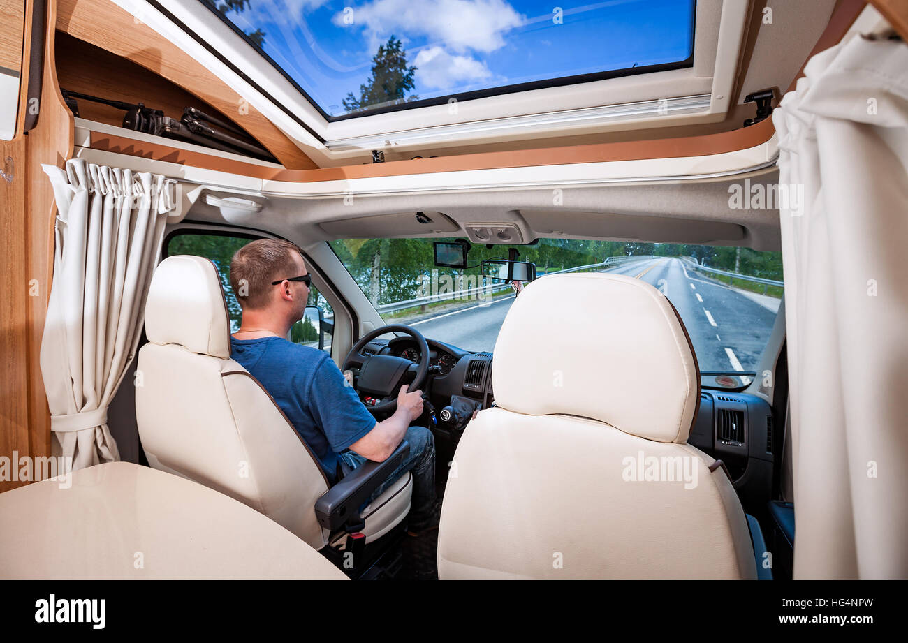 Man driving on a road in the Camper Van. Caravan car Vacation. Family ...