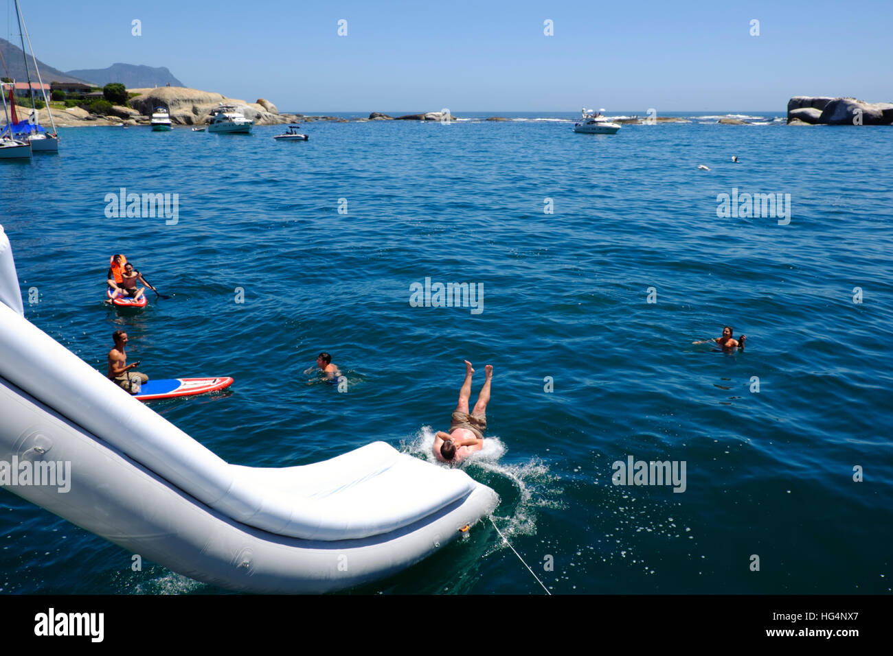 Tourist having fun on a slide from the top deck of a luxury yacht at ...