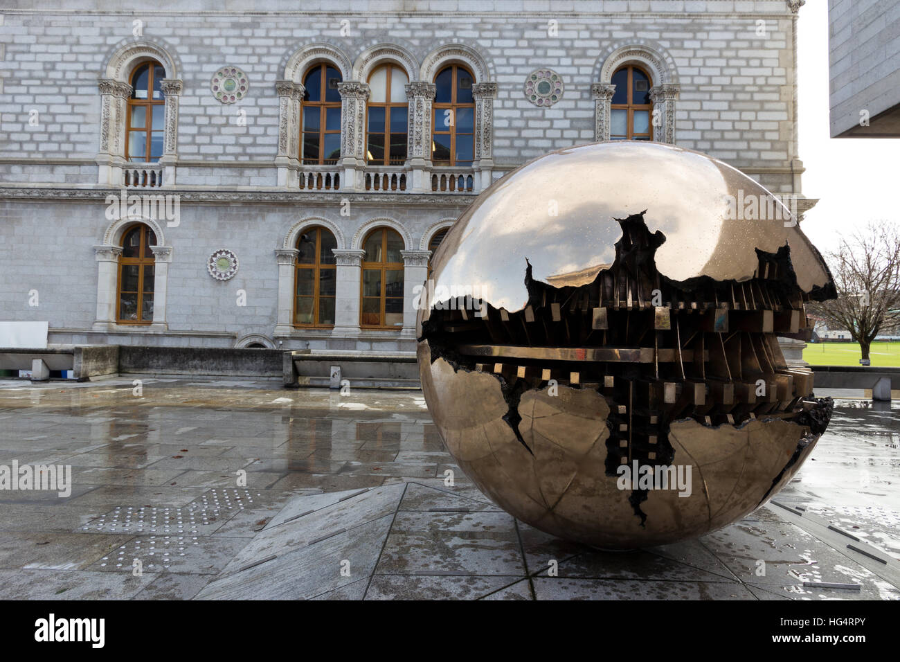 Abstract spherical metal sculpture on a courtyard of Trinity College ...