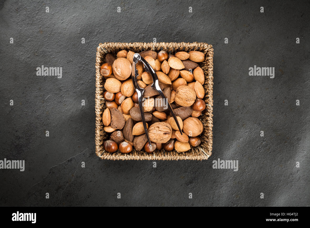 Assortment of nuts on dark slate background Stock Photo - Alamy